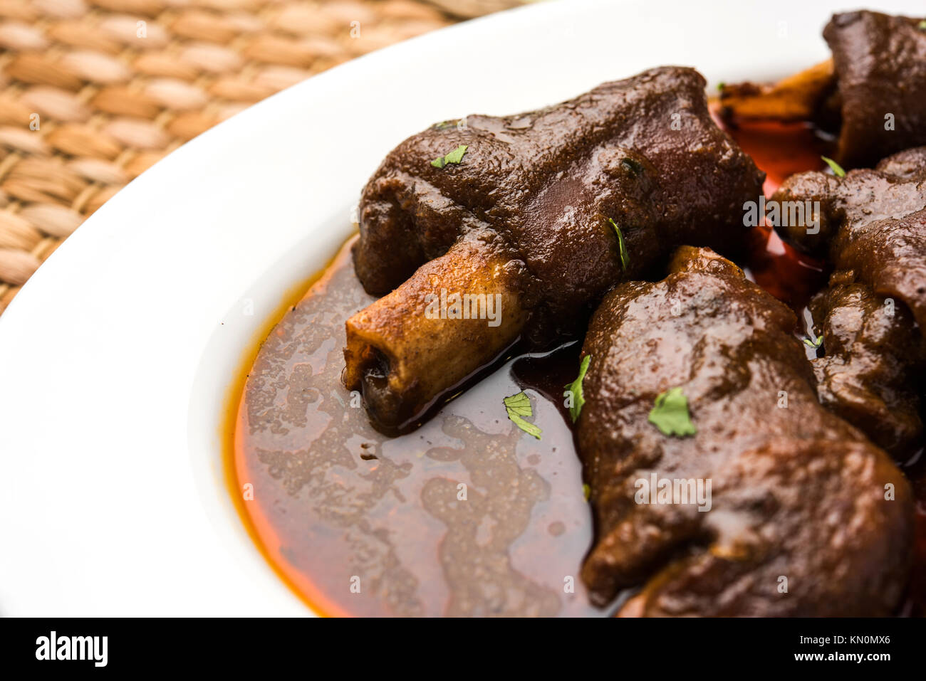 lamb shank or mutton or gosht paya or khoor curry served with indian ...
