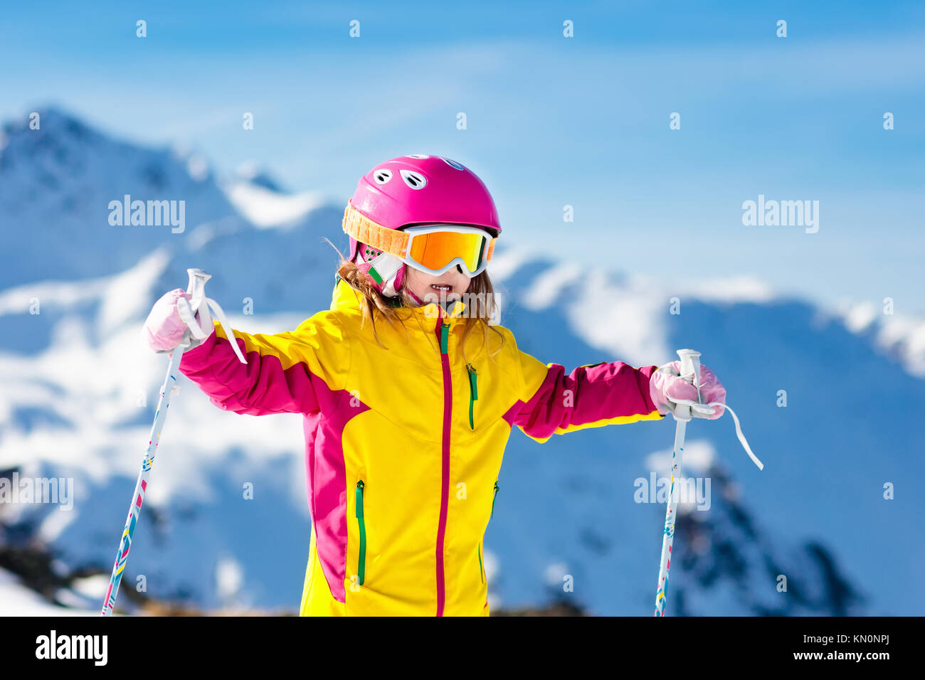 Child skiing in mountains. Active toddler kid with safety helmet ...