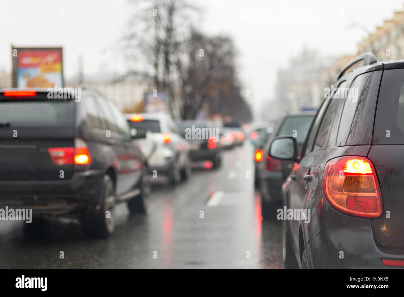 Cars in a traffic jam on a city street on wet road after rain Stock Photo - Alamy