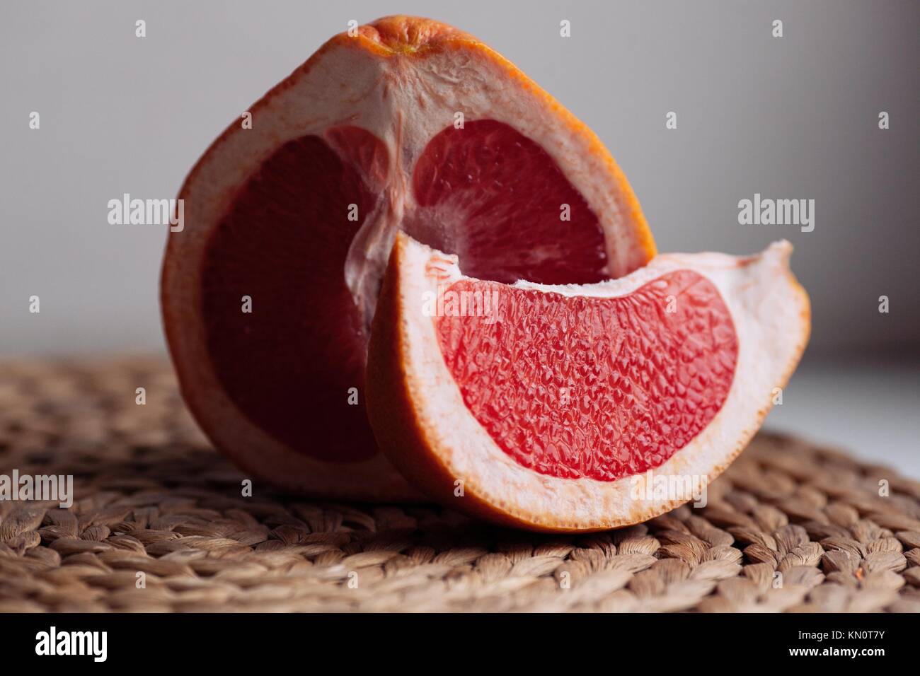 A piece of grapefruit on a table near the window Stock Photo - Alamy