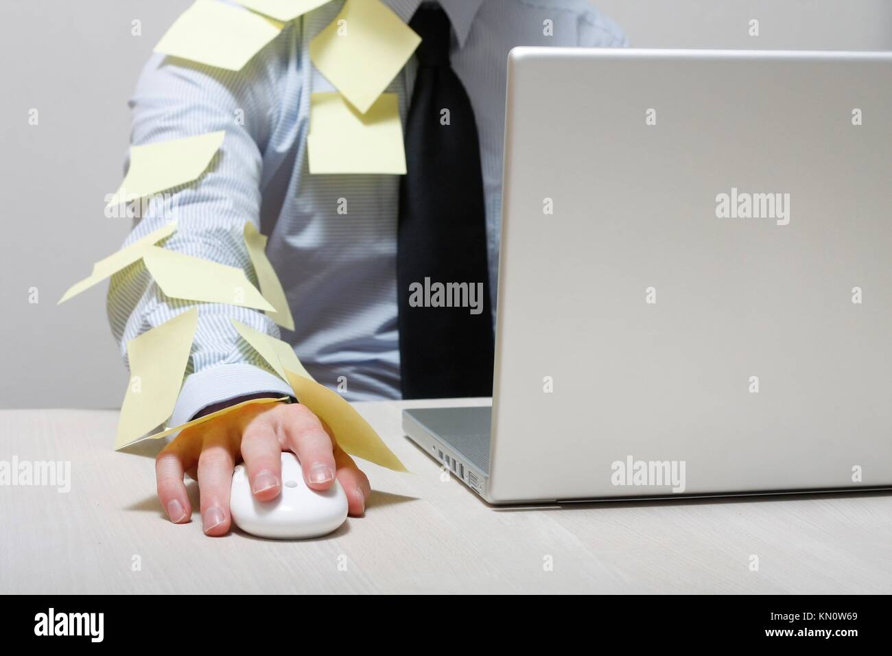 A man covered in yellow notes by a laptop Stock Photo - Alamy