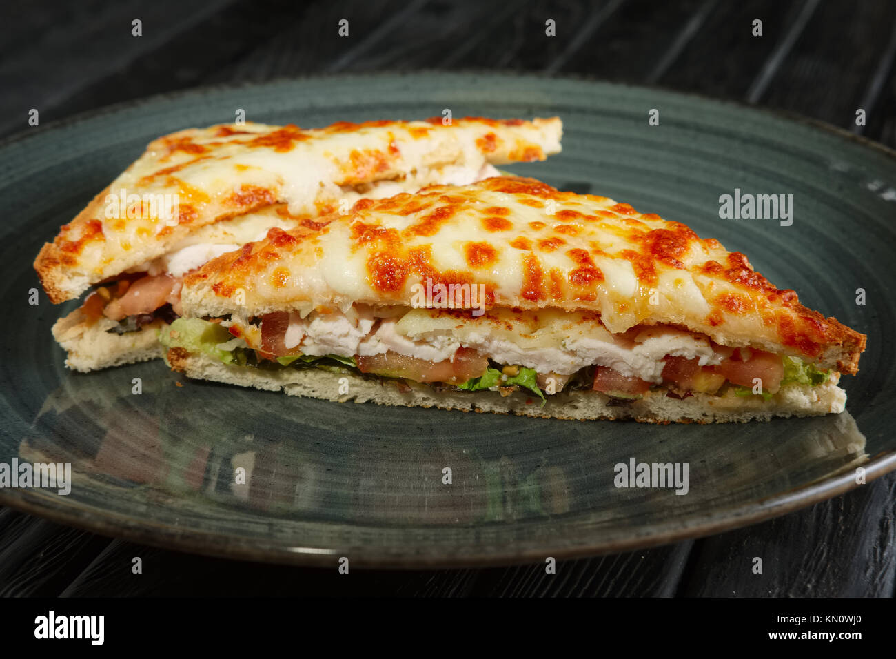 Club sandwich with chicken fillet, pickled cucumber , salad and melted ...