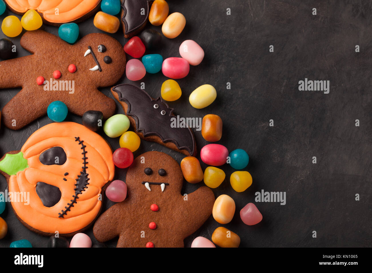 Halloween pumpkin, bat and gingerbread man-vampire cookies and colorful ...