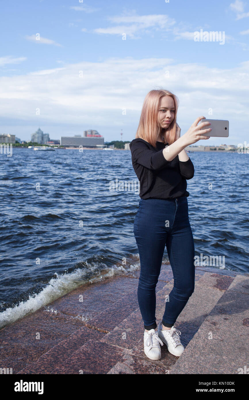 Young cute girl makes selfie on the waterfront of St. Petersburg Stock ...