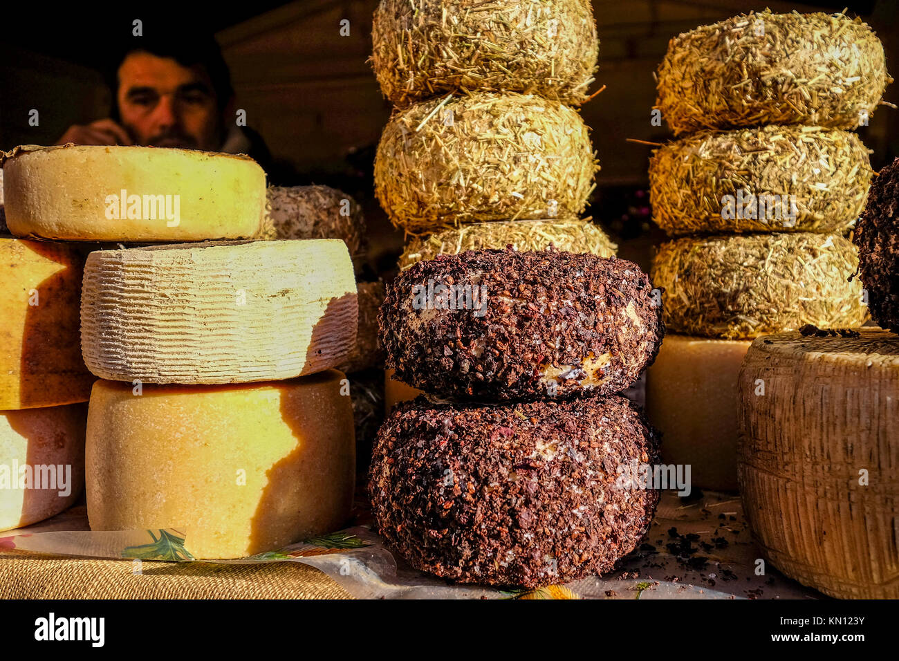 herbs and pepper seasoned cheeses are on display in the window of a ...