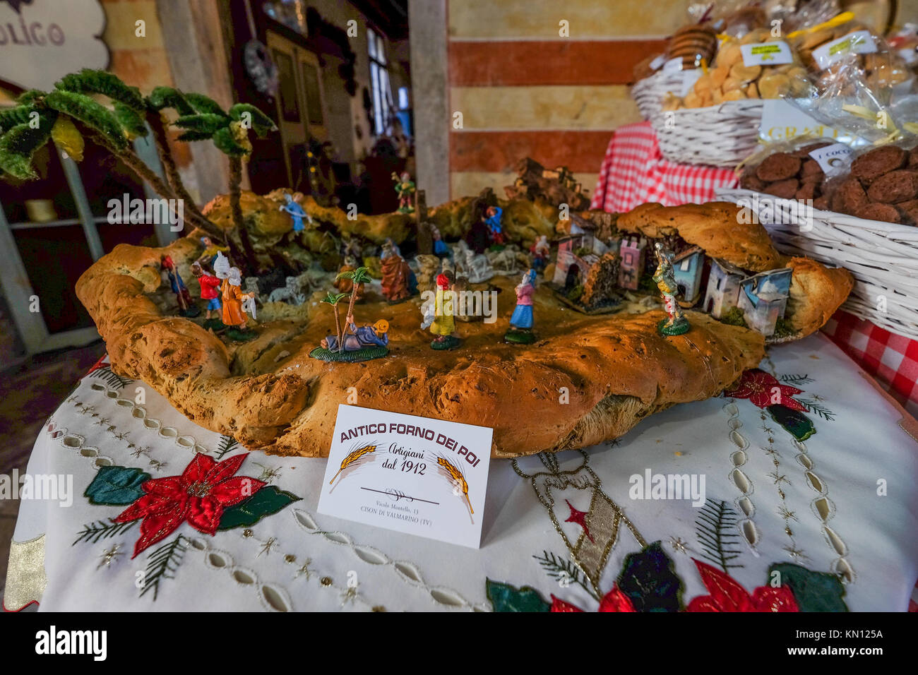 A Nativity Scene made with breads is on display at the window of a ...
