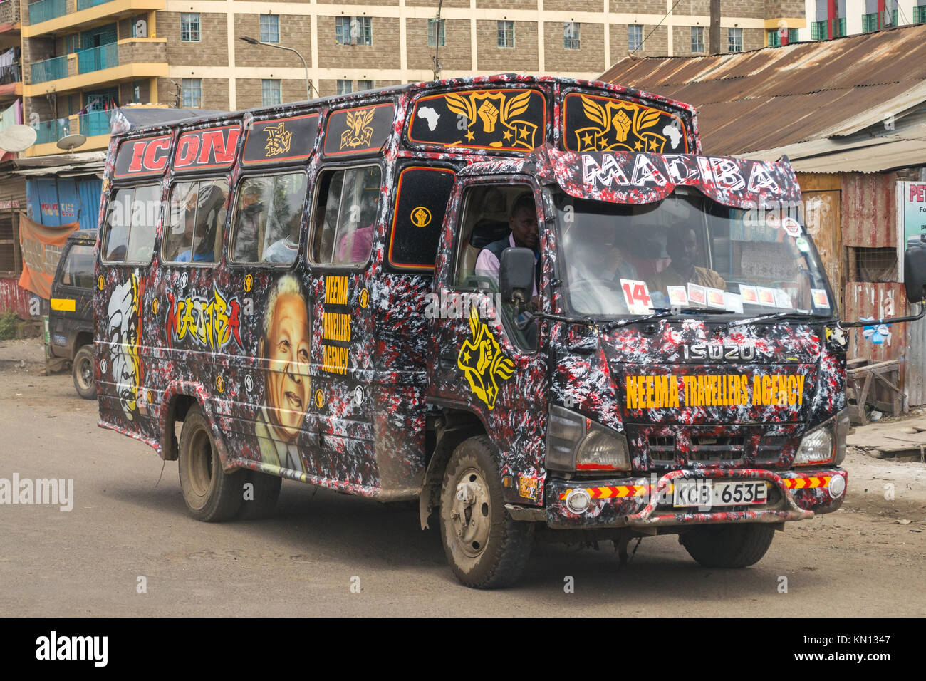 A bus brightly decorated with art driving on the road, Nairobi, Kenya ...