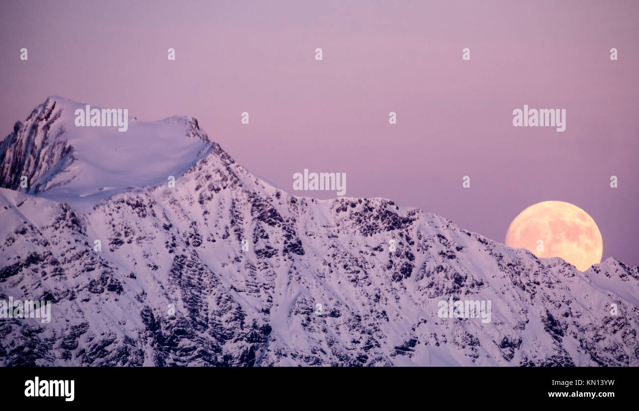 full moon rise over enchanting winter mountain landscape in the Swiss ...