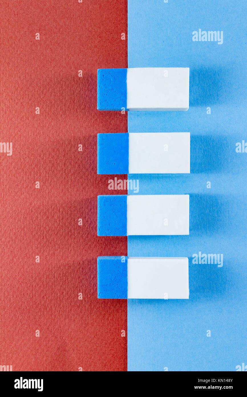 Top view of blue and white erasers on blue and brown color papers ...