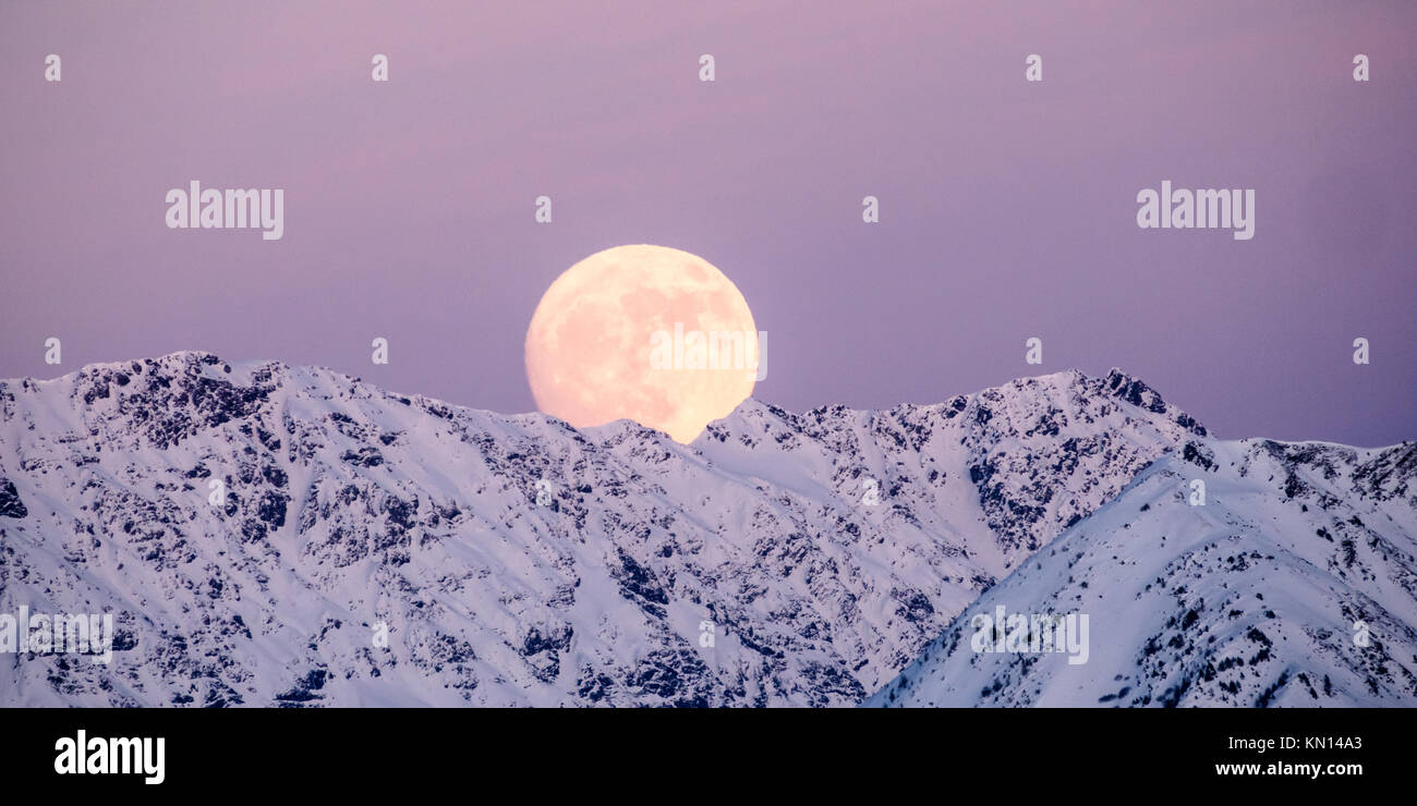 full moon rise over enchanting winter mountain landscape in the Swiss ...