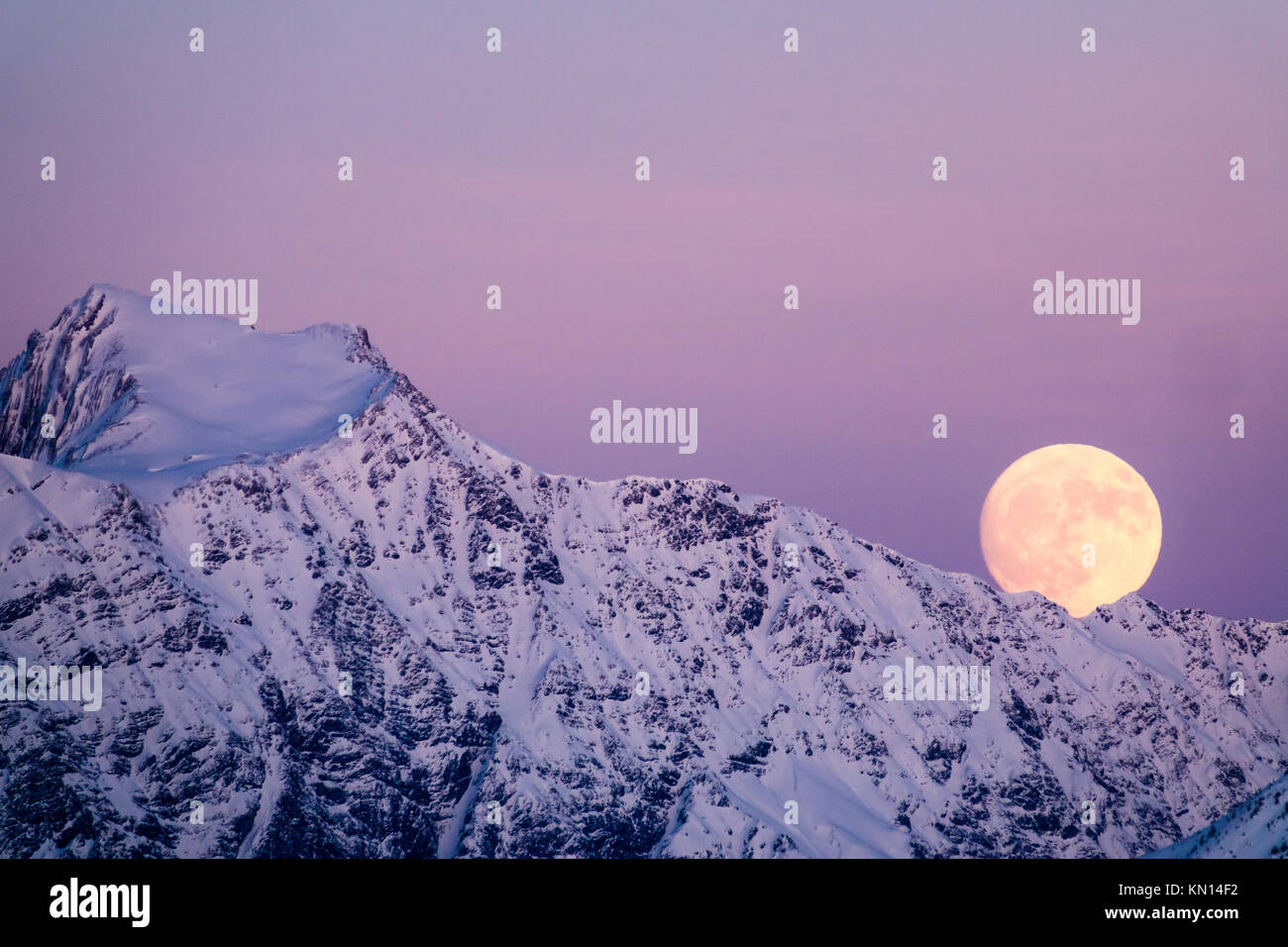 full moon rise over enchanting winter mountain landscape in the Swiss ...