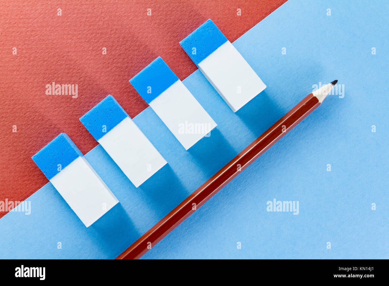 Top view of blue and white erasers on blue and brown color papers ...