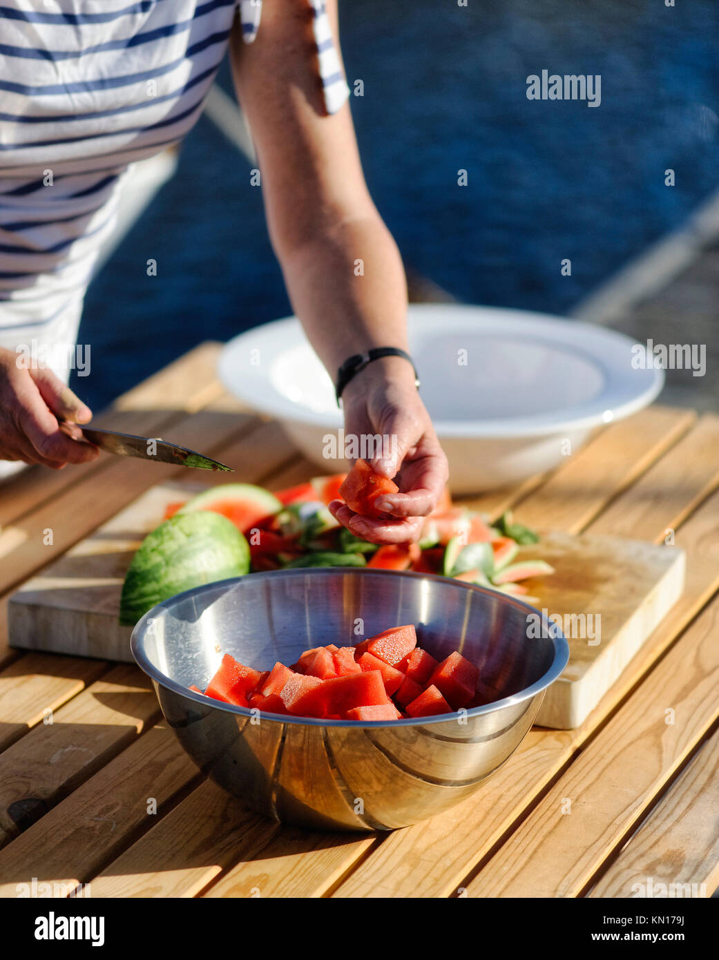 Woman preparing Melon dish in the harbor Stock Photo - Alamy