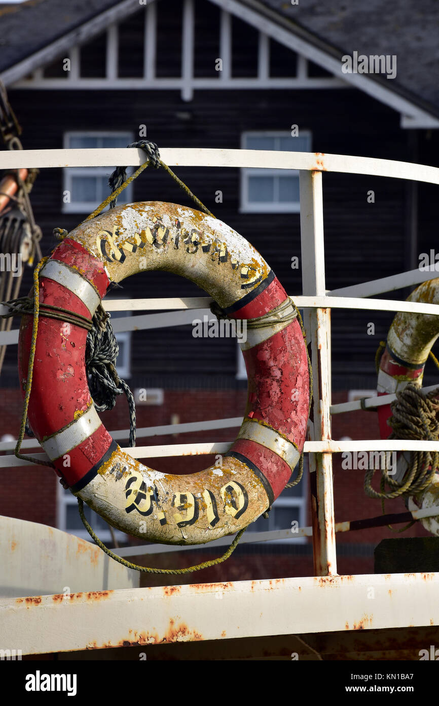 an old lifebuoy or life belt ring on the railings of an old abandoned ...