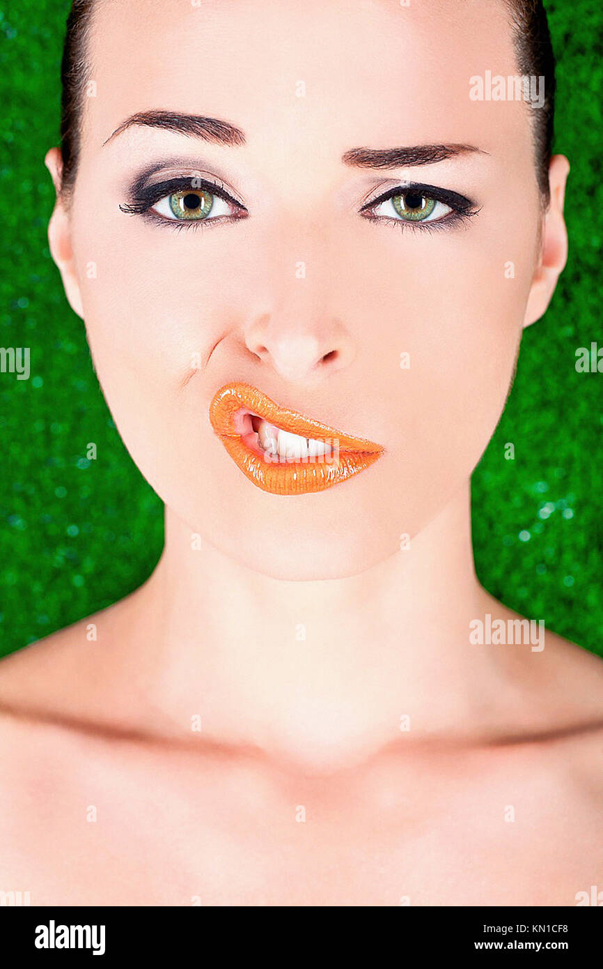 Closeup fashion portrait of a woman pulling a strange face isolated on ...