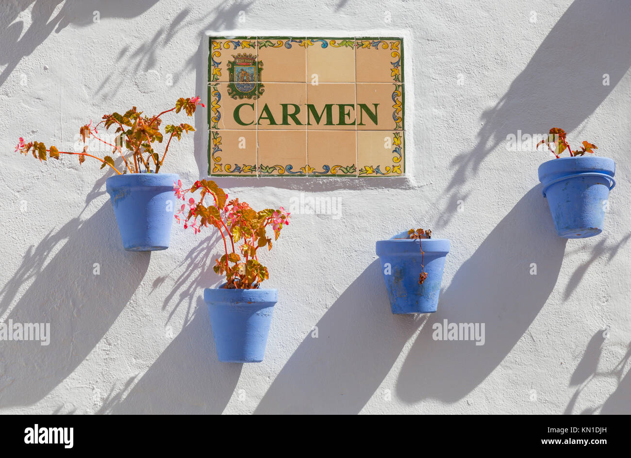 Wall mounted blue flower pots and tiled street name, Calle Carmen ...