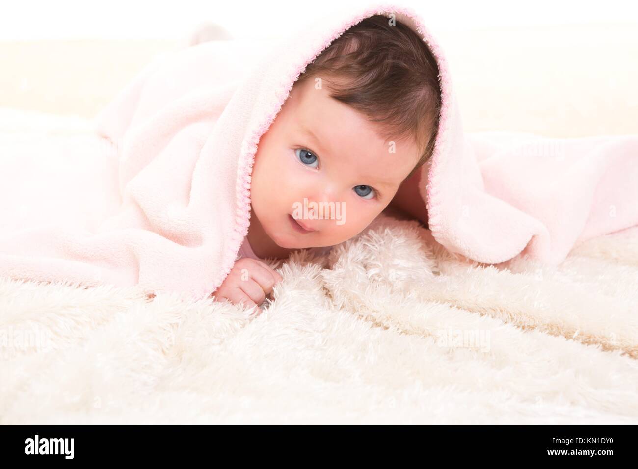 baby girl under hidden pink blanket on winter white fur background ... baby girl under hidden pink blanket on winter white fur background ...