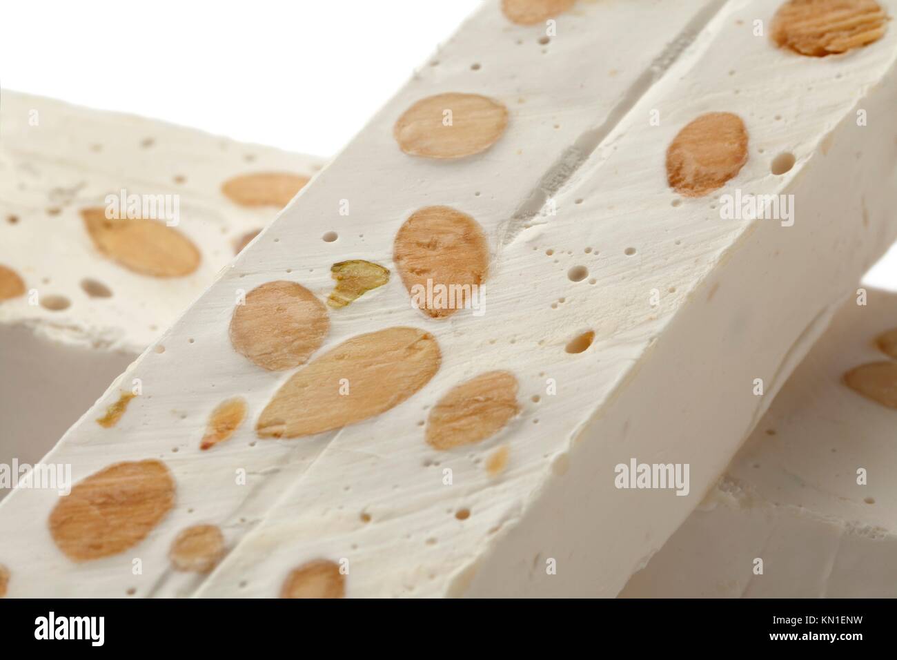 Bars of Nougat with almonds and pistachio nuts on white background ...