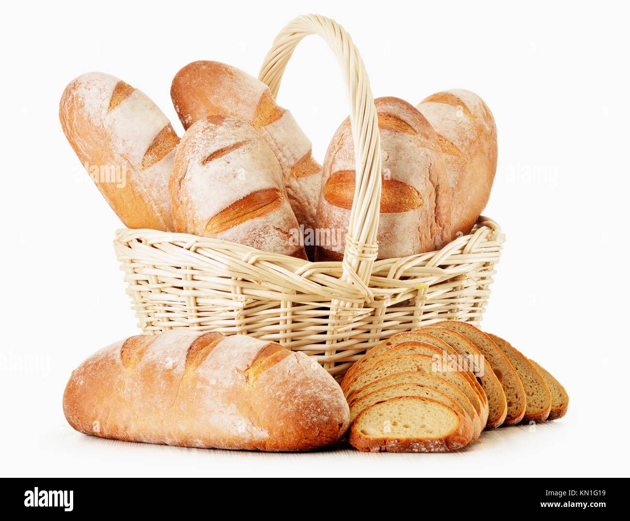 Composition with loafs of bread in wicker basket isolated on white ...
