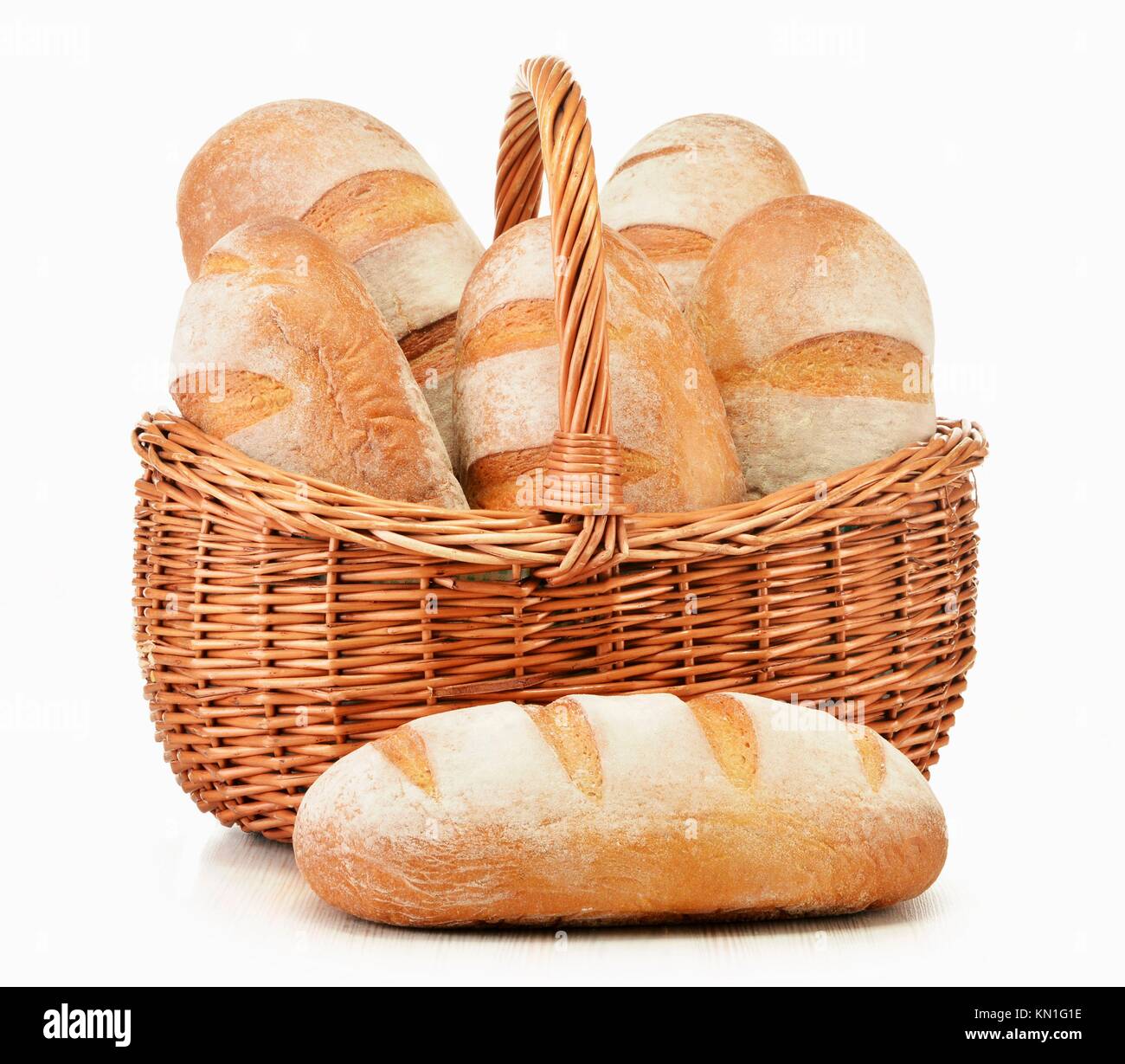 Composition with loafs of bread in wicker basket isolated on white ...