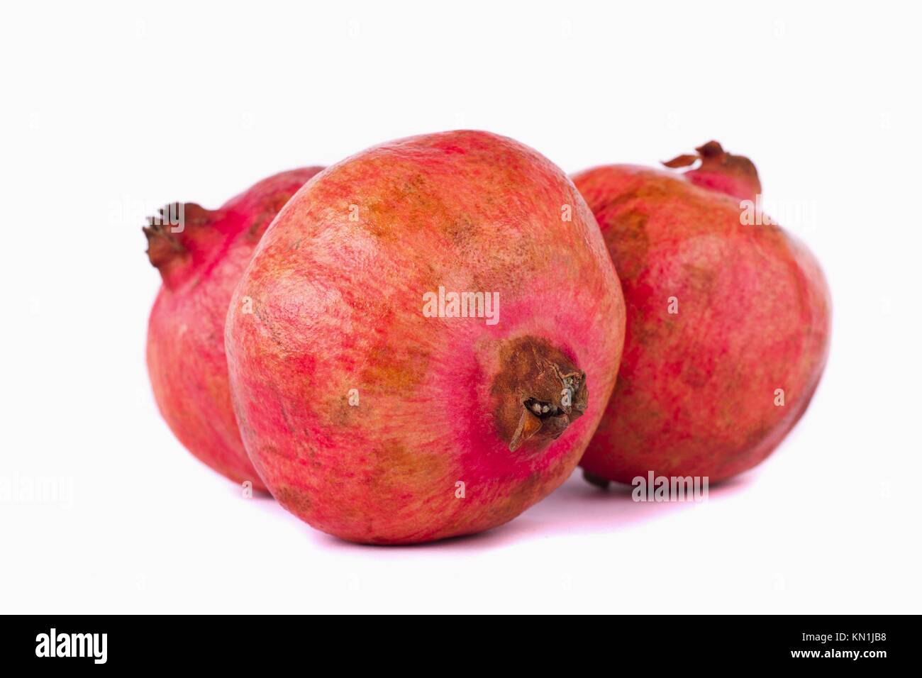 Close up view of some pomegranate fruit isolated on a white background ...