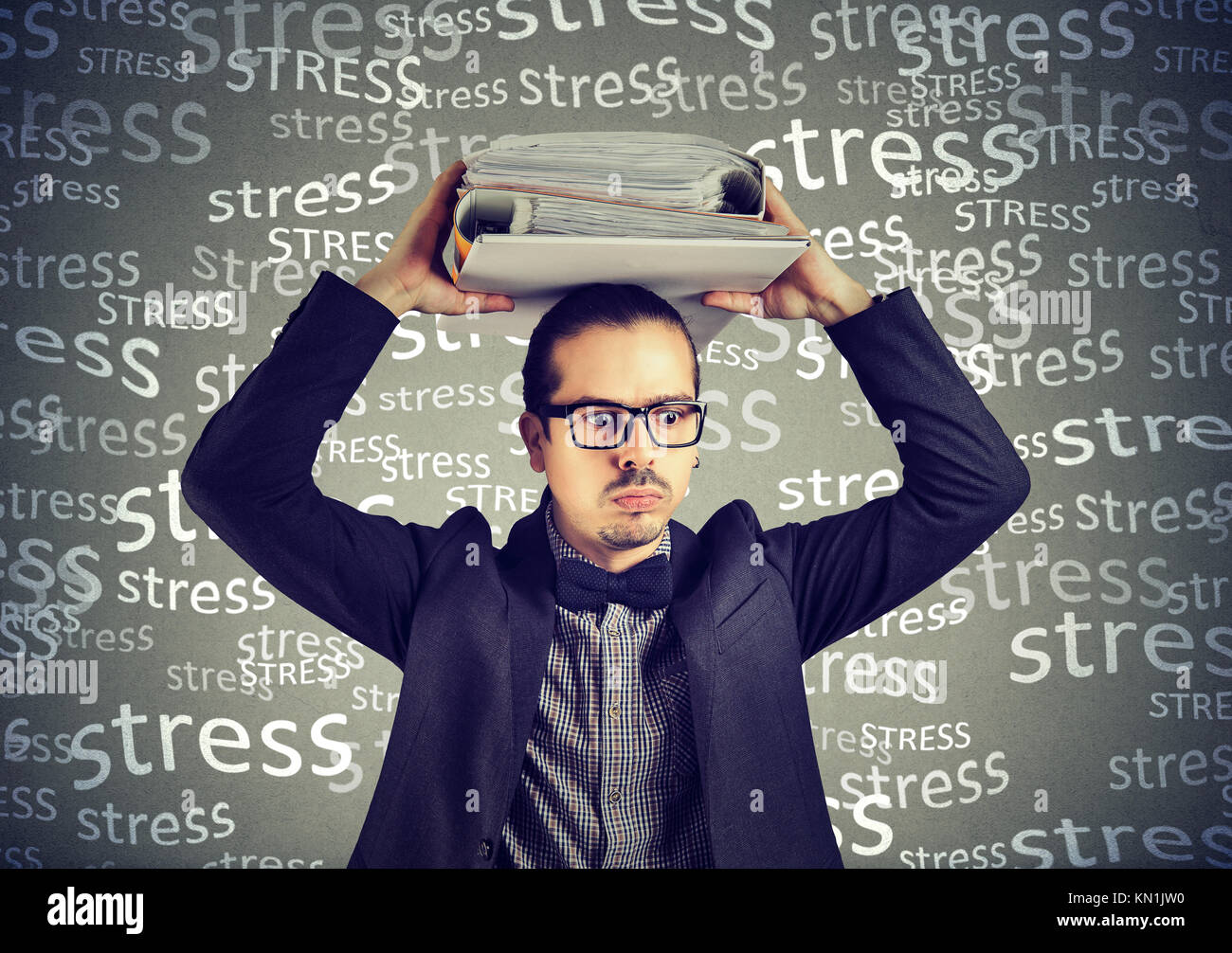 Stressed doomed business man standing with heavy folders on his head ...