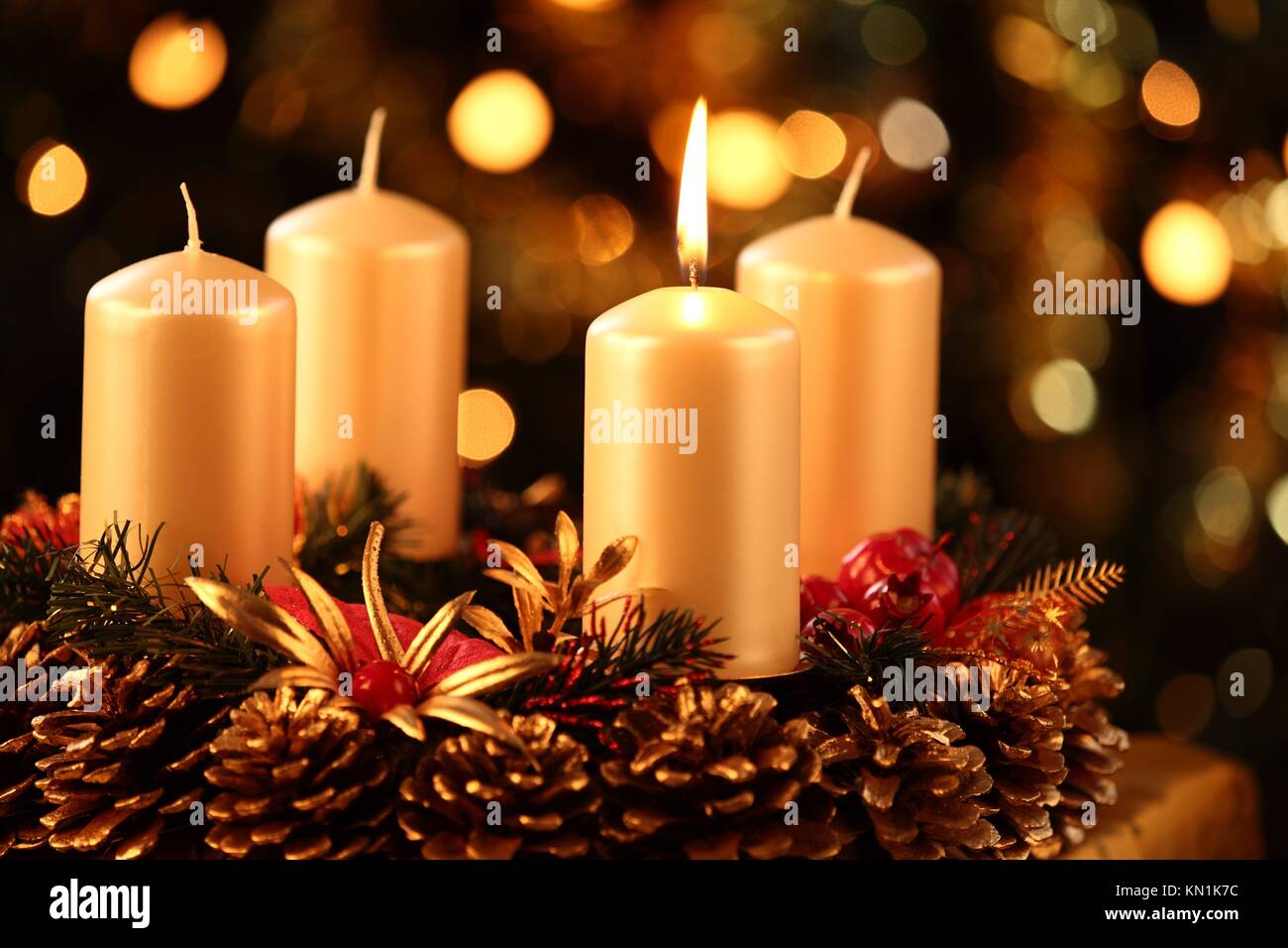 One golden burning advent candle hi-res stock photography and images ...