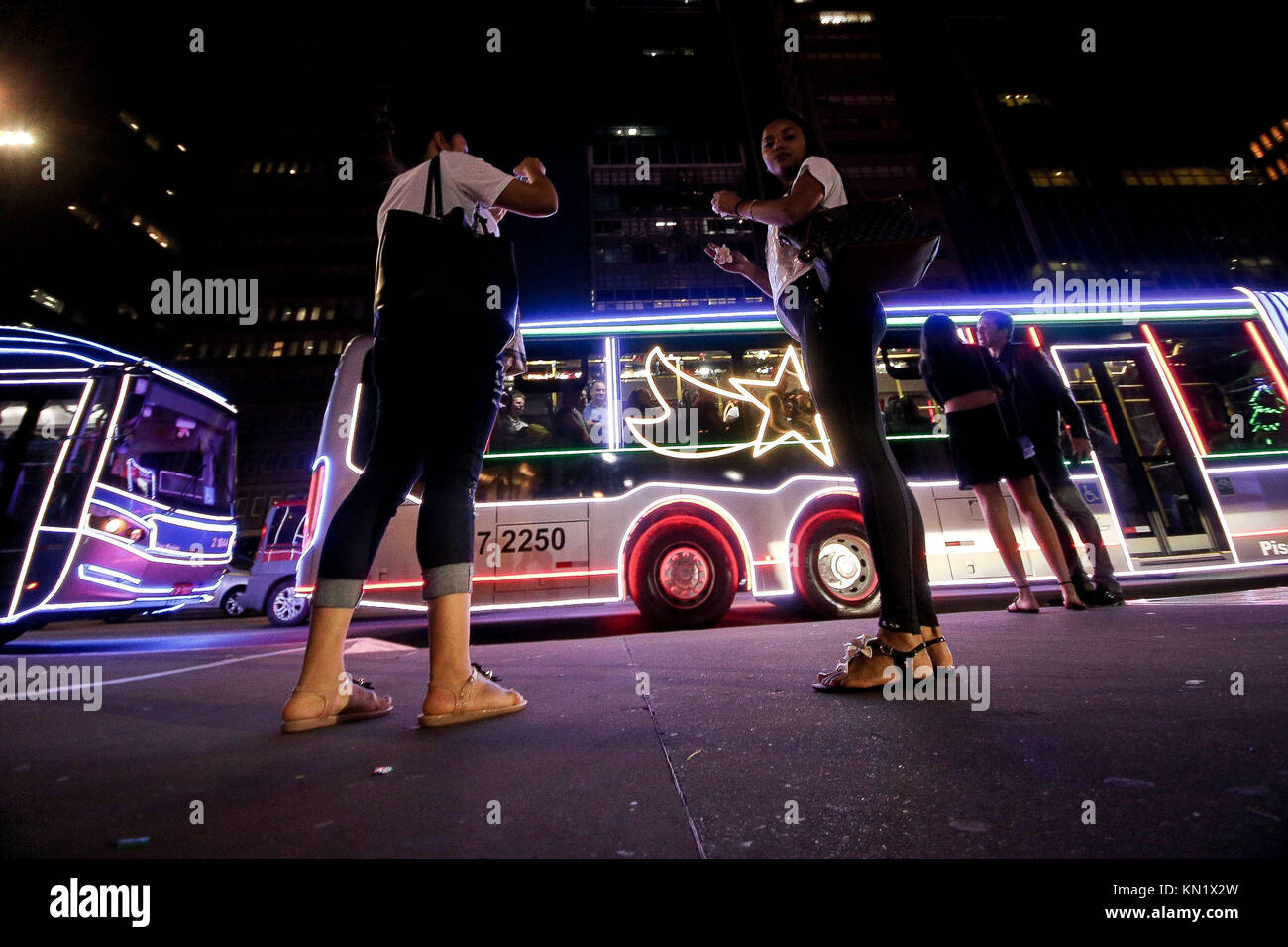 Sao Paulo, Brazil. 9th Dec, 2017. People watch buses decorated with LED ...