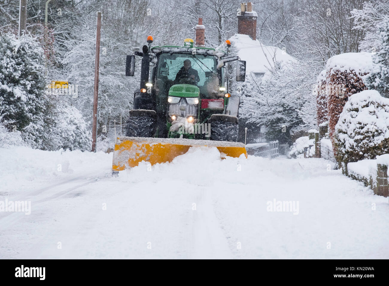 A tractor snow plough at work clearing overnight snow in Shifnal ...