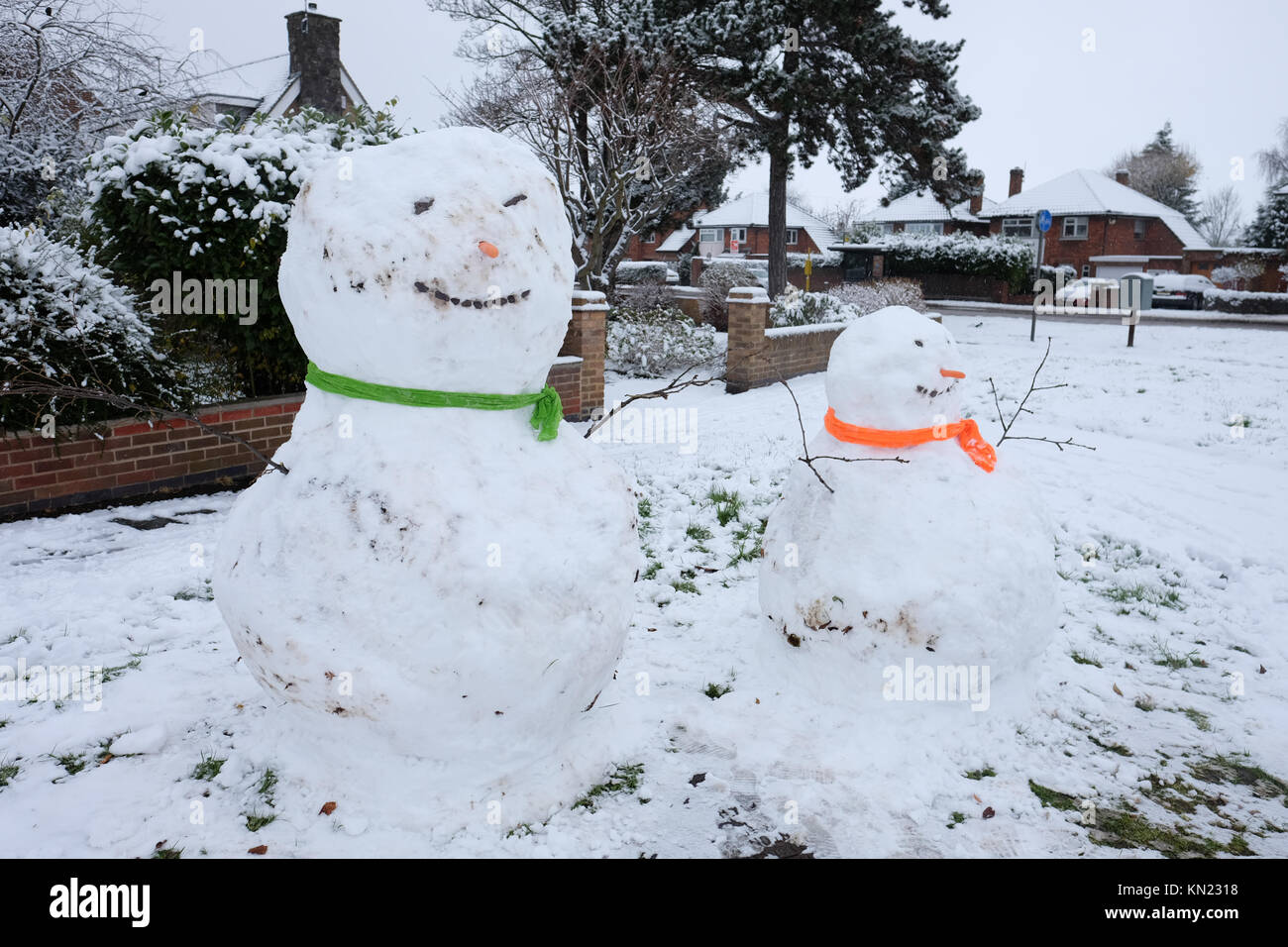 two snowmen built after heavy snow Stock Photo - Alamy