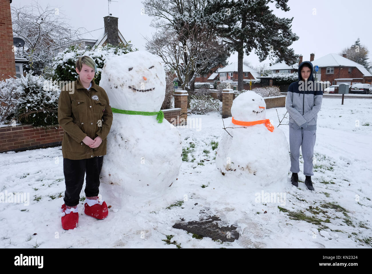 young people pose with snowman they had made Stock Photo - Alamy