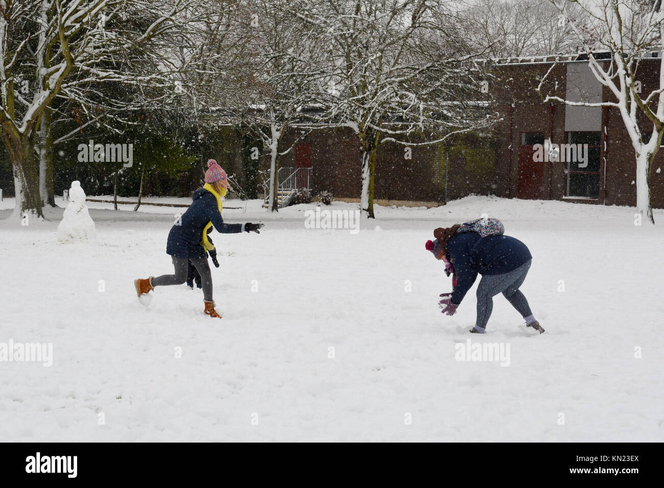 Bedford, England. 10 December 2017: Two women having a snowball fight ...