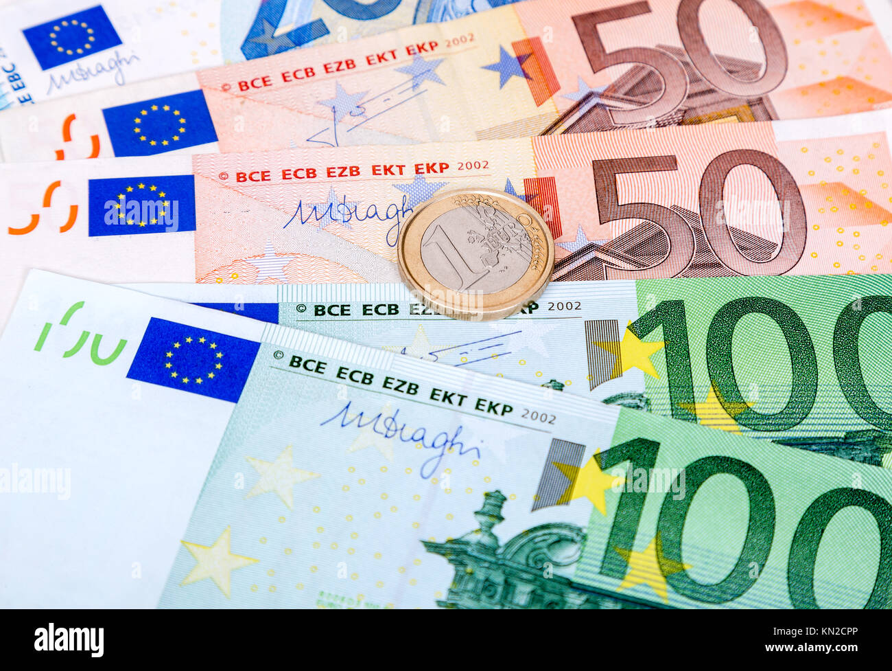 Coin one euro lying on a euro currency banknotes Stock Photo - Alamy