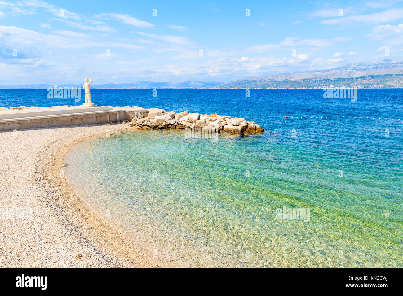 View of beach with turquoise sea water in Postira village, Brac island ...