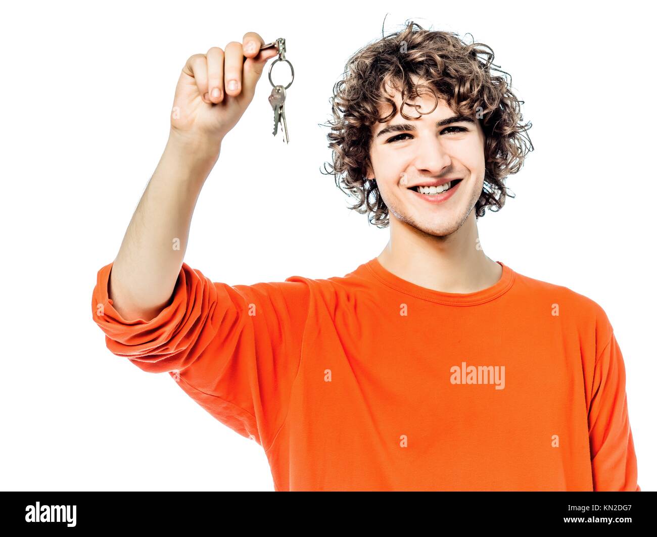 one young man caucasian holding keys portrait in studio white ...