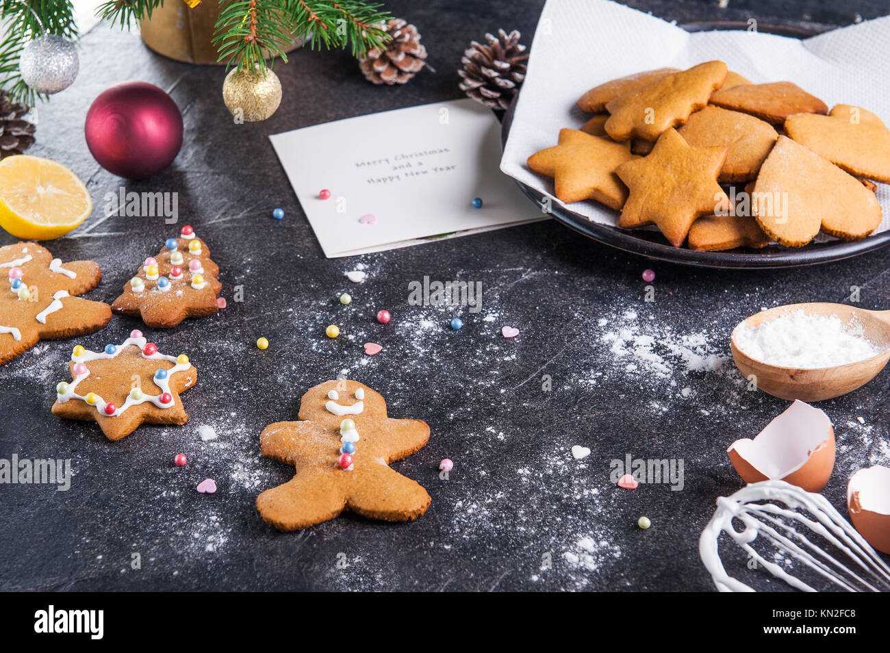 Christmas homemade gingerbread cookies and postcard on the black stone ...