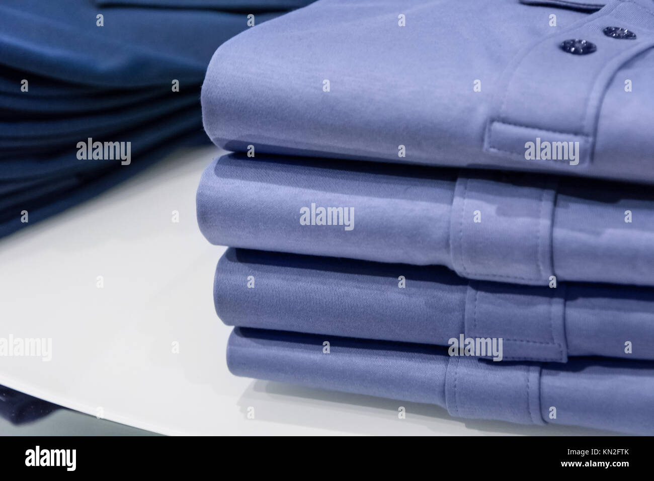 stack of neatly folded clothes on the counter Stock Photo - Alamy