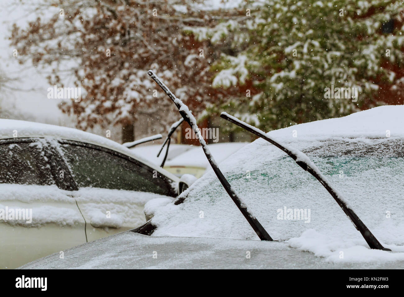 Frozen car covered snow at winter day, view front window windshield and ...