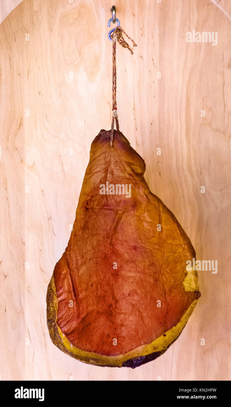 Serrano ham shown hanging on Stock Photo - Alamy