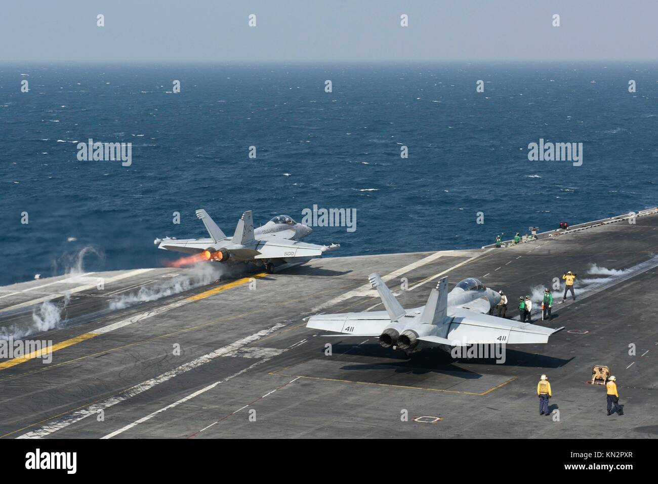 A U.S. Navy EA-18G Growler electronic warfare aircraft (left) and a U.S ...