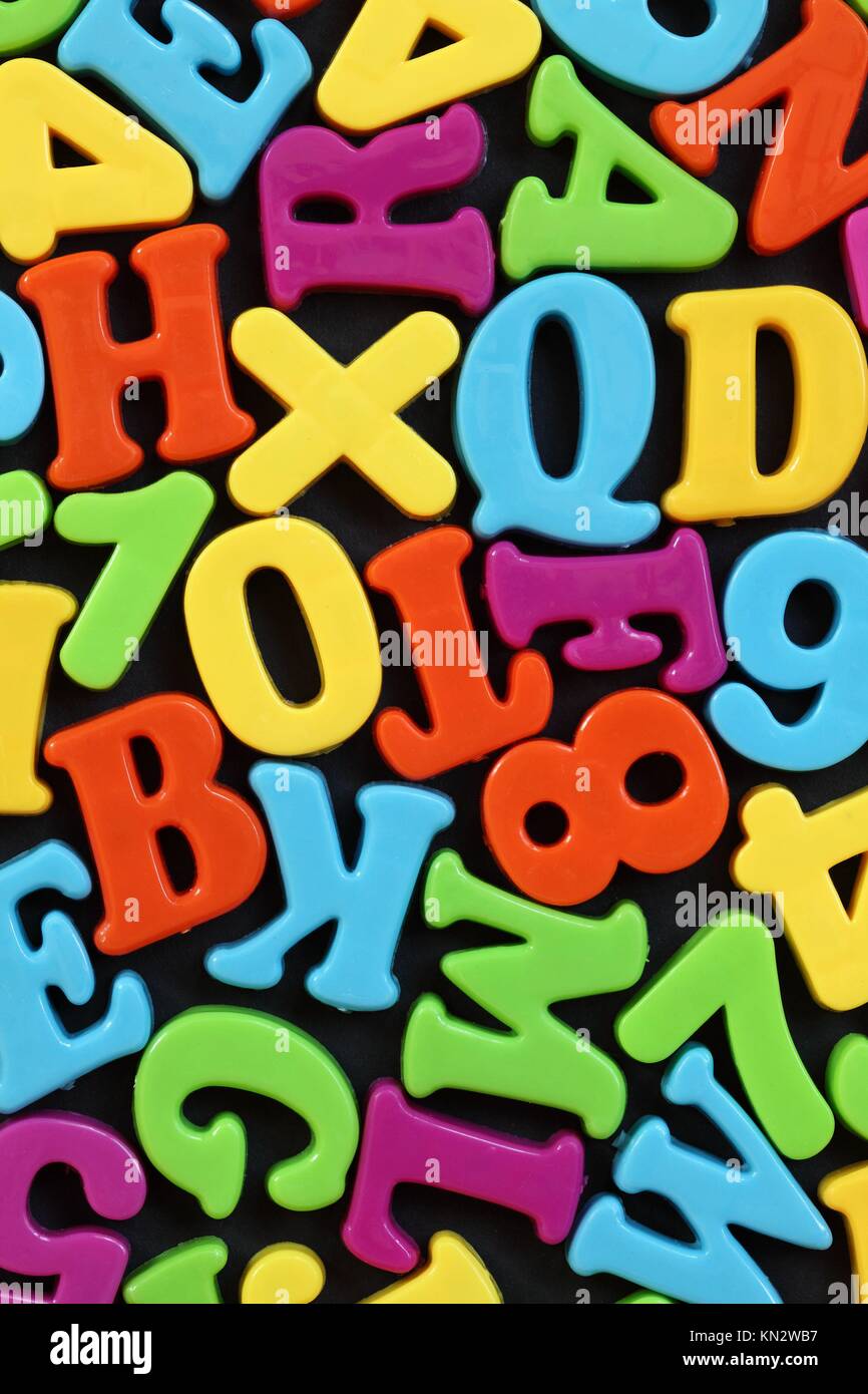 Colorful numbers and letters on black background Stock Photo - Alamy