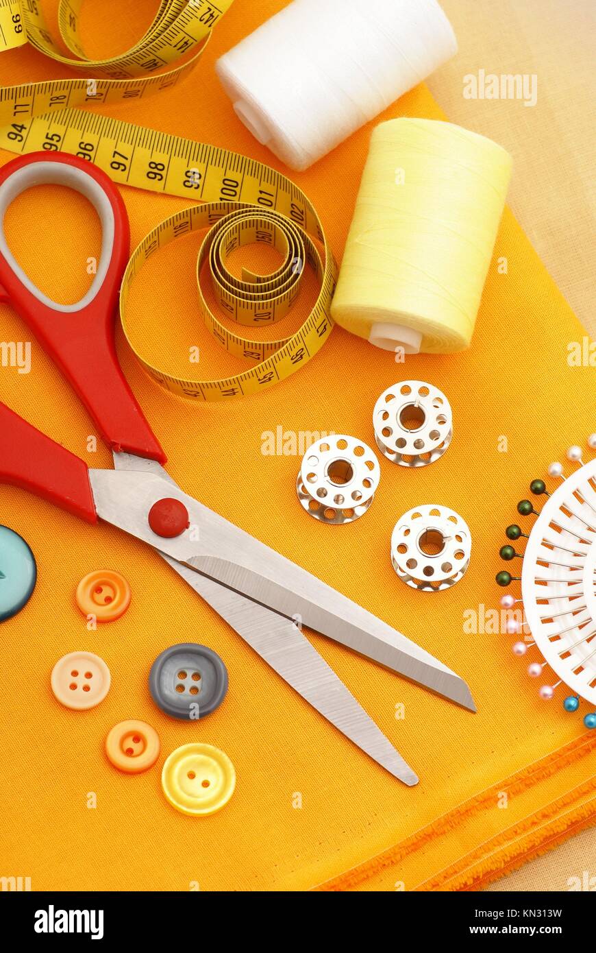 Various sewing items on cloth Stock Photo - Alamy