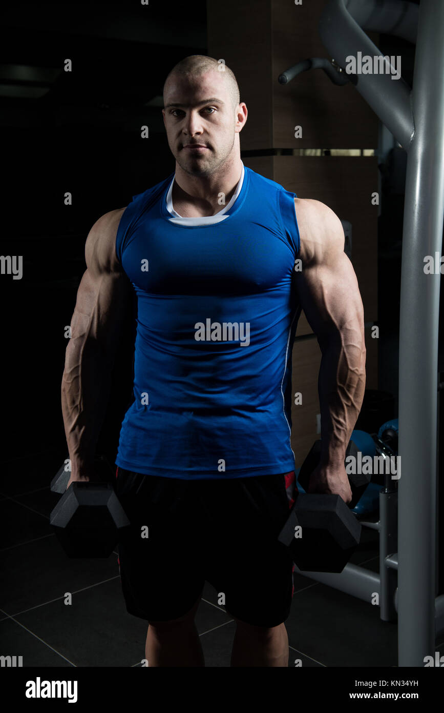 Man Working Out Biceps In A Gym - Dumbbell Concentration Curls Stock ...