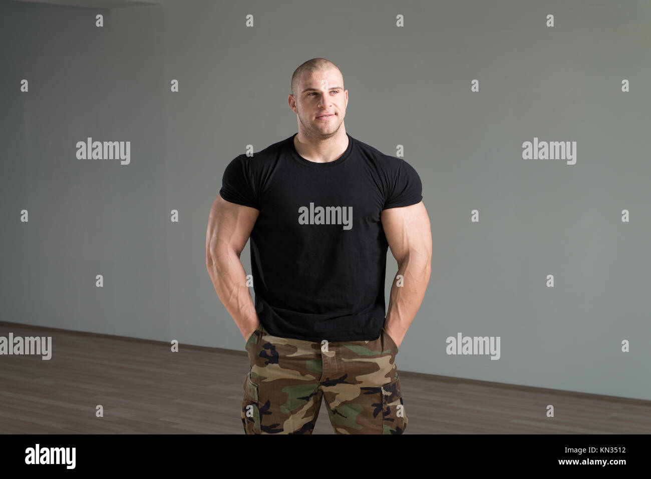 Healthy Man Standing Strong In Army Pants And Flexing Muscles ...