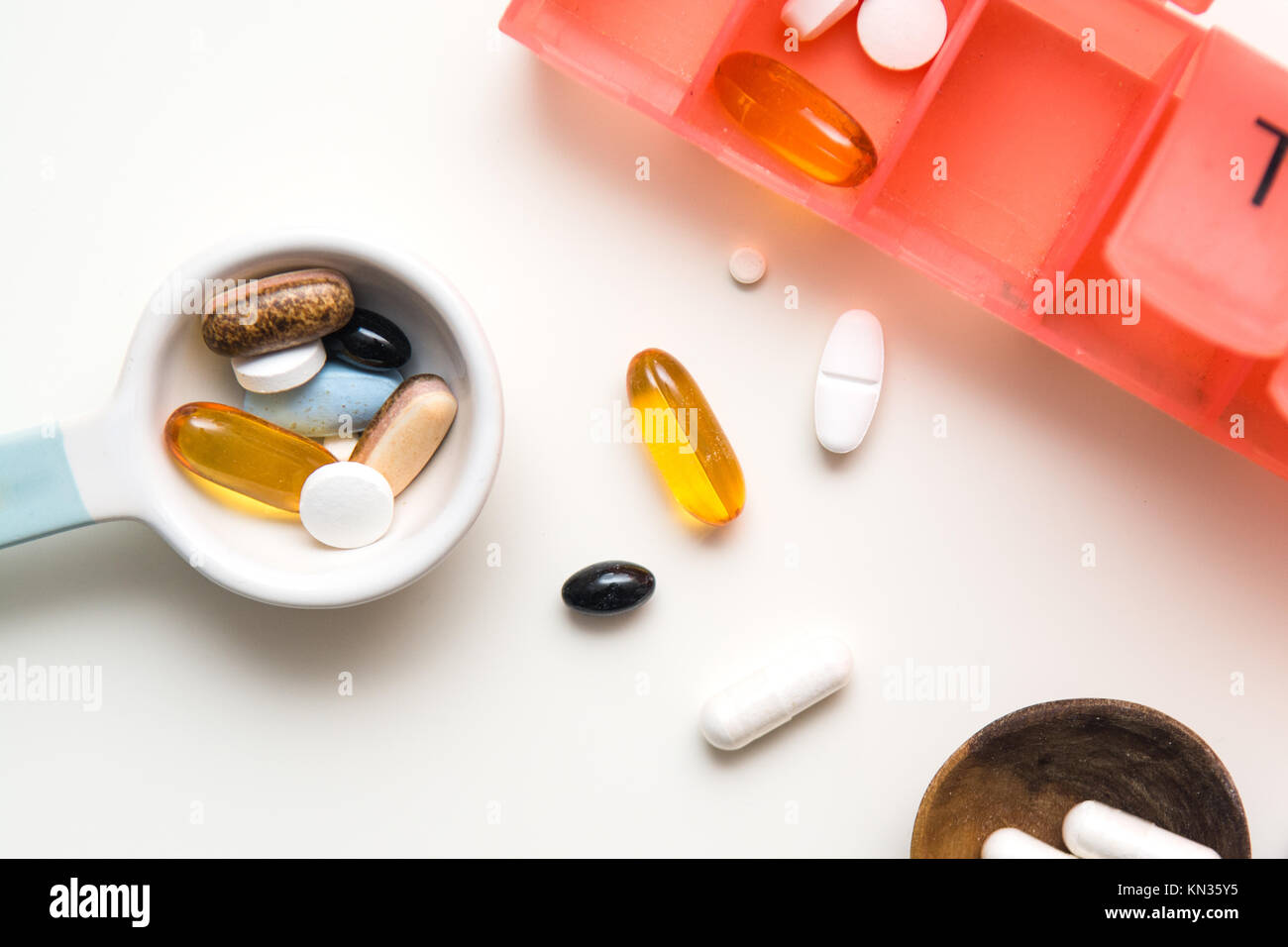 Medicine measured out for a daily dose to take tablets Stock Photo - Alamy