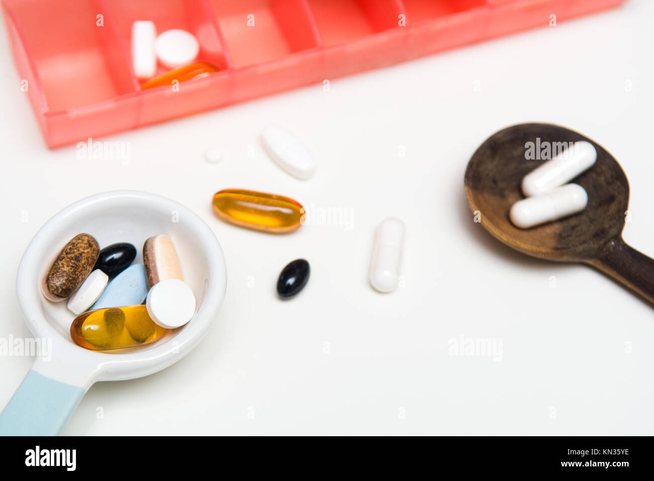 Medicine measured out for a daily dose to take tablets Stock Photo - Alamy