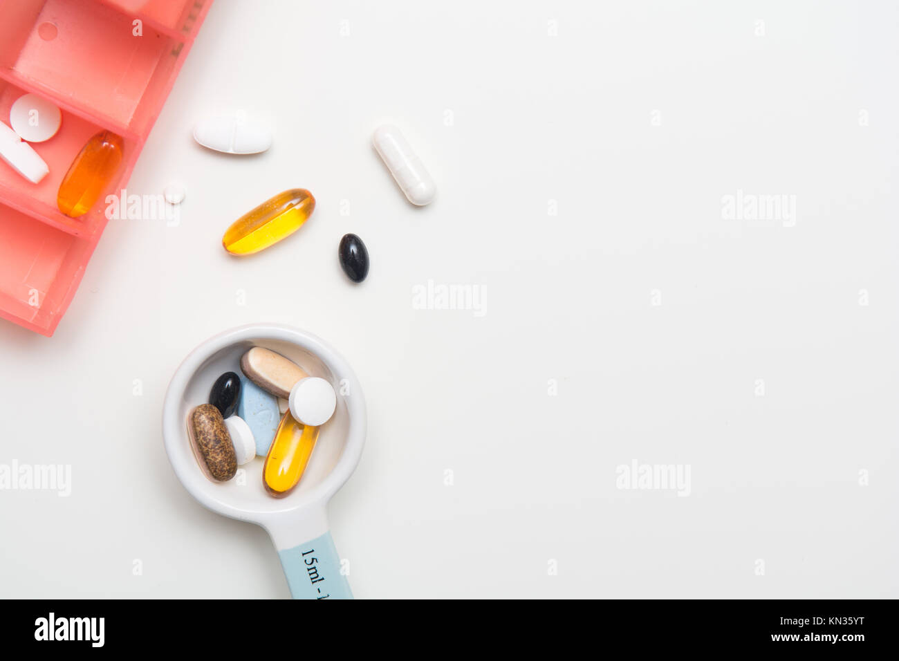 Medicine measured out for a daily dose to take tablets Stock Photo - Alamy