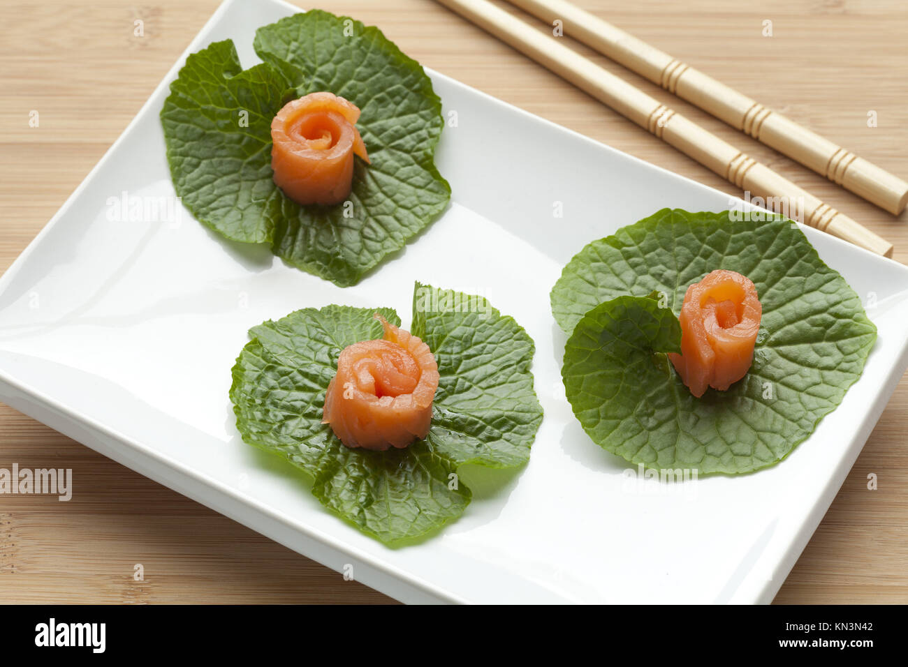 Japanese starter smoked salmon on wasabi leaves Stock Photo - Alamy