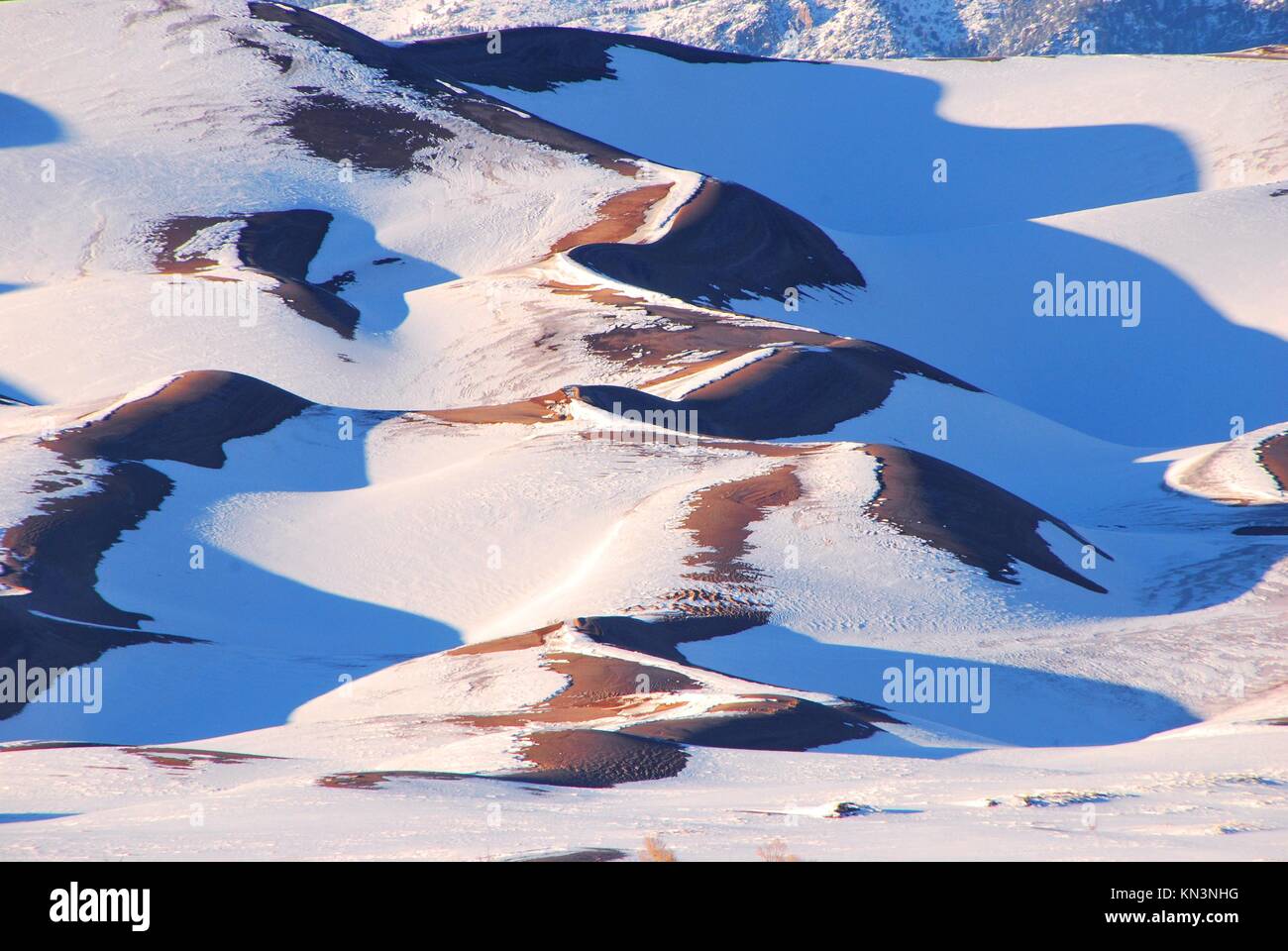 Snow covers the sand dunes at the Great Sand Dunes National Park and ...