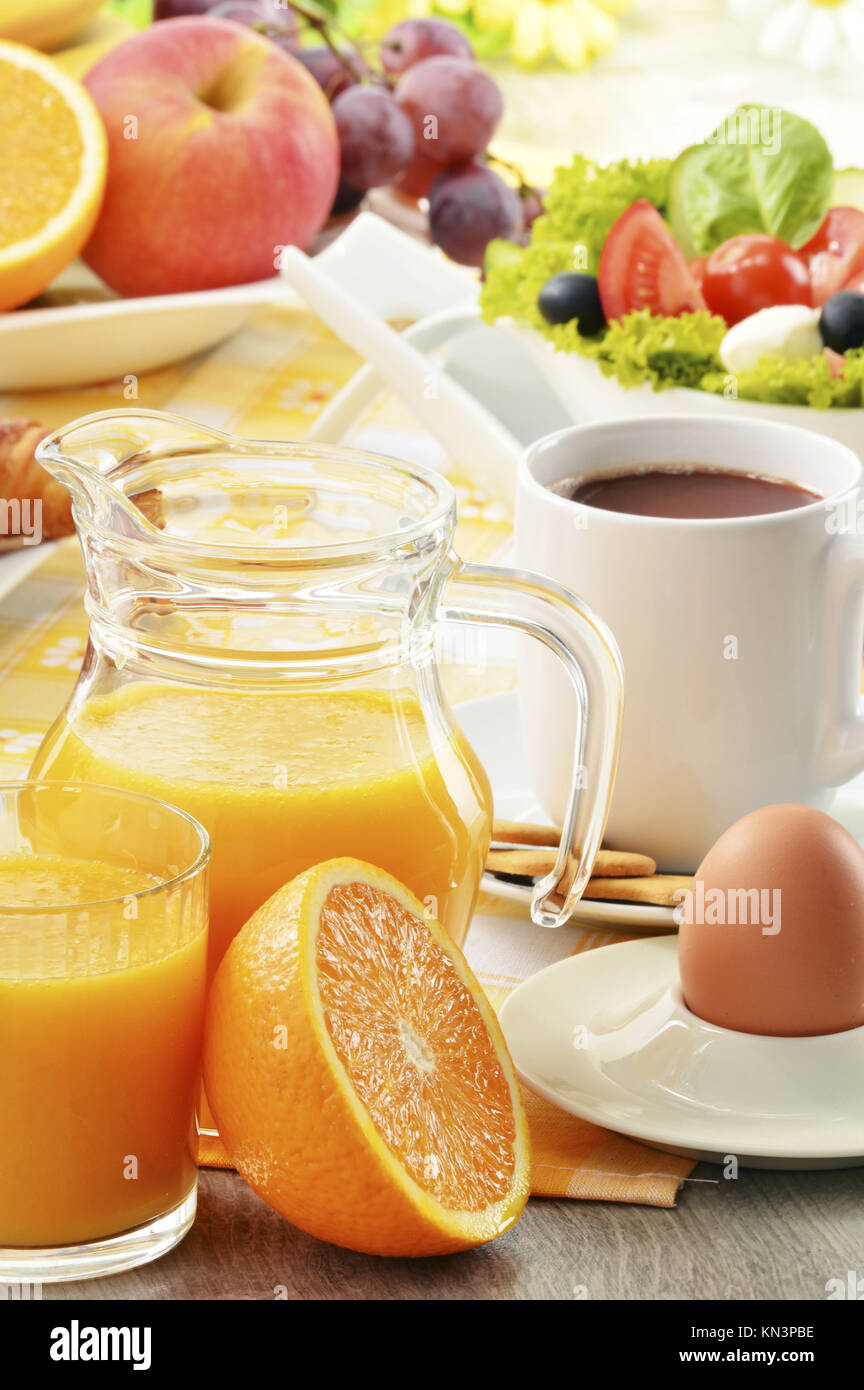 Breakfast with coffee, orange juice, croissant, egg, vegetables and ...